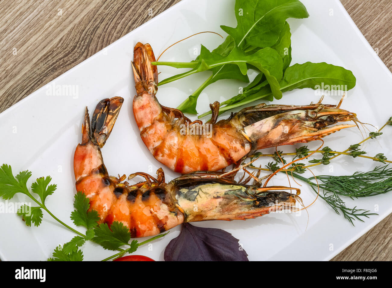 Roasted tiger shrimps with thyme and basil leaves Stock Photo - Alamy