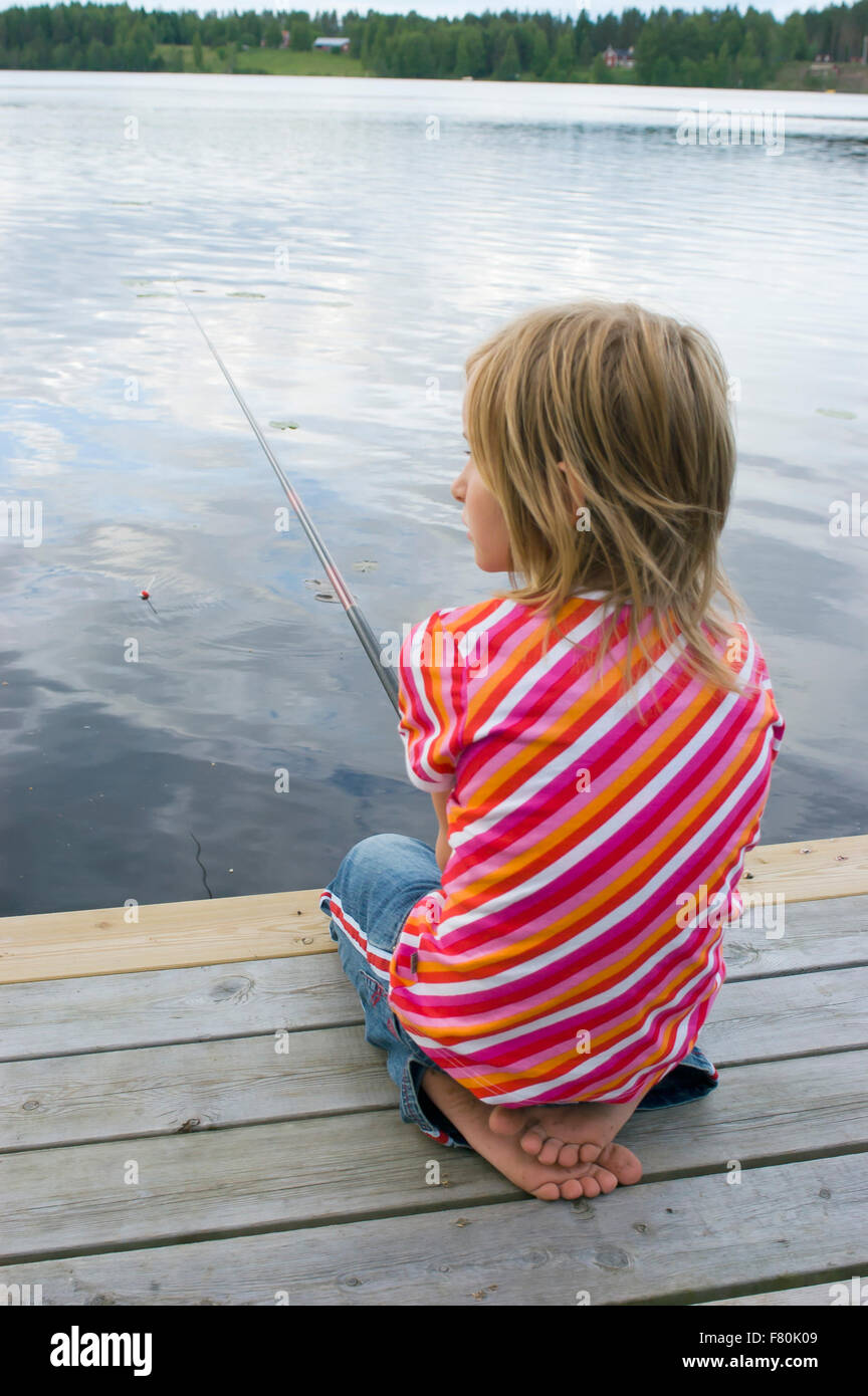 Girl with fishing rod Stock Photo - Alamy