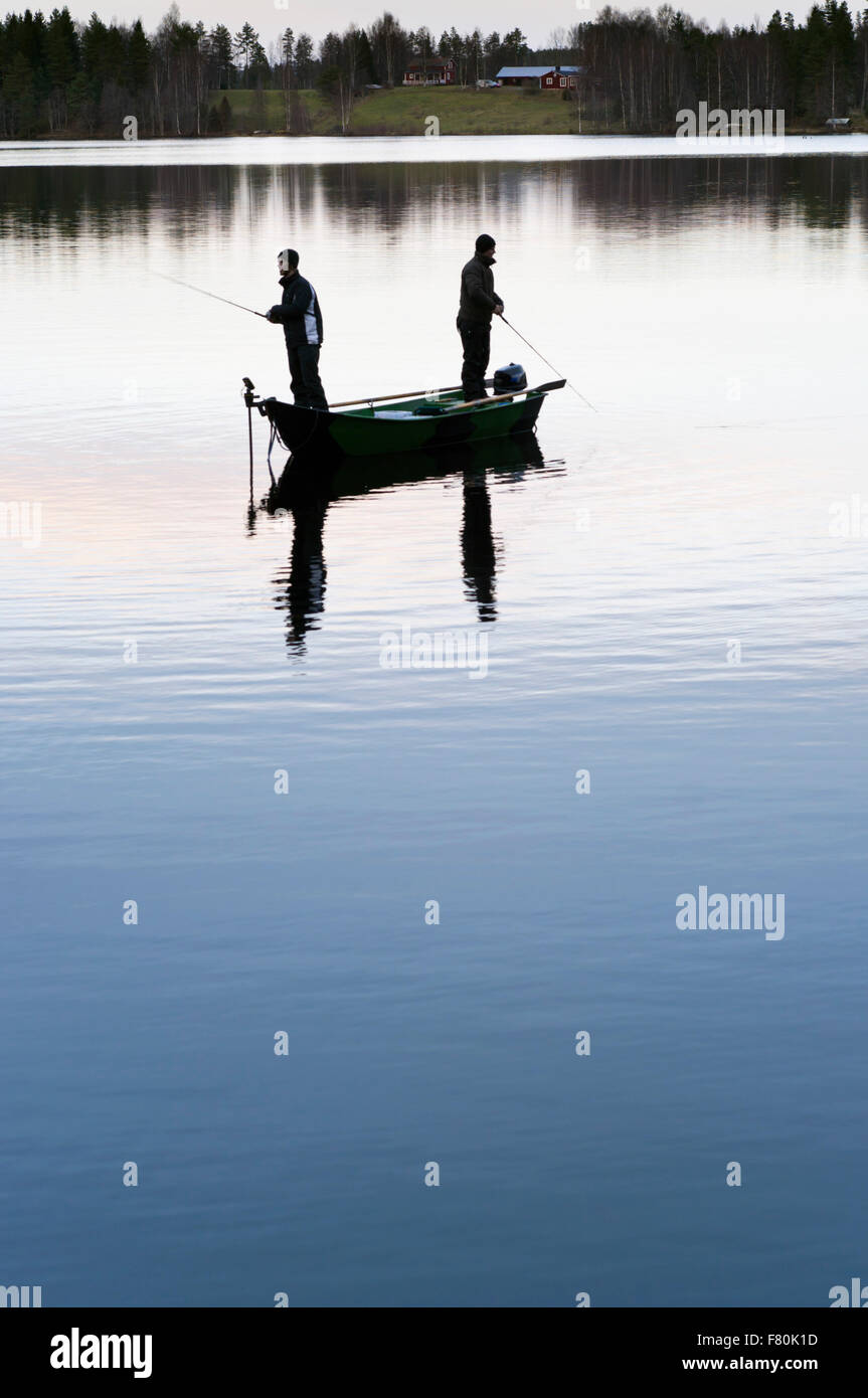 Fishing at dusk Stock Photo - Alamy