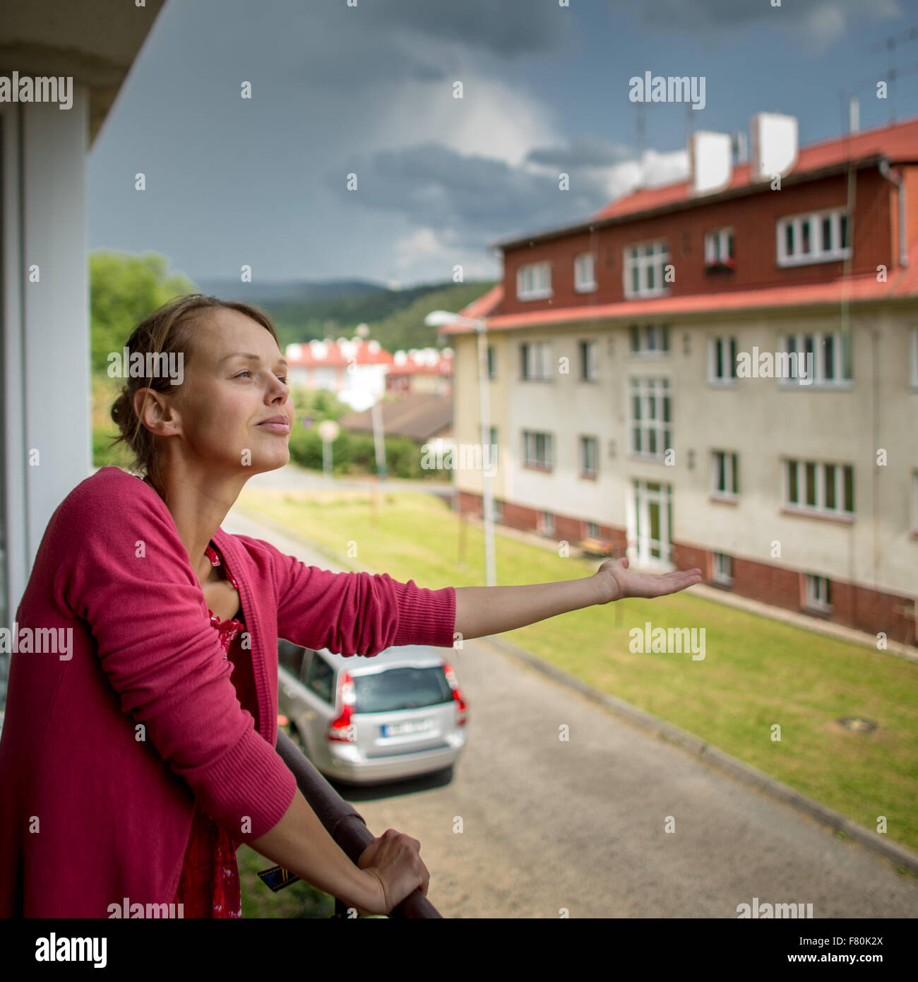 Pretty, young woman checking weather it is raining already from the ...