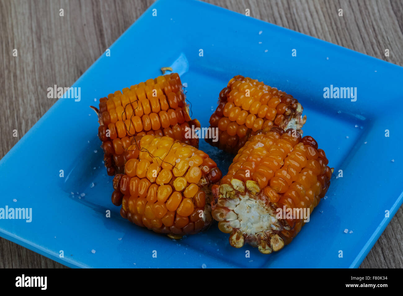 Grilled salted corn on the wood background Stock Photo - Alamy