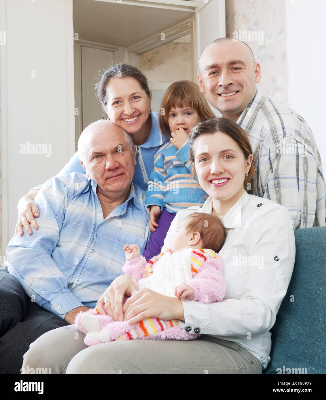 Portrait o three generations family in home Stock Photo - Alamy