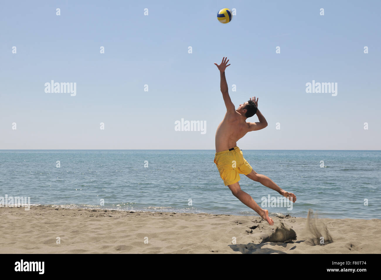 male beach volleyball game player jump on hot sand Stock Photo - Alamy