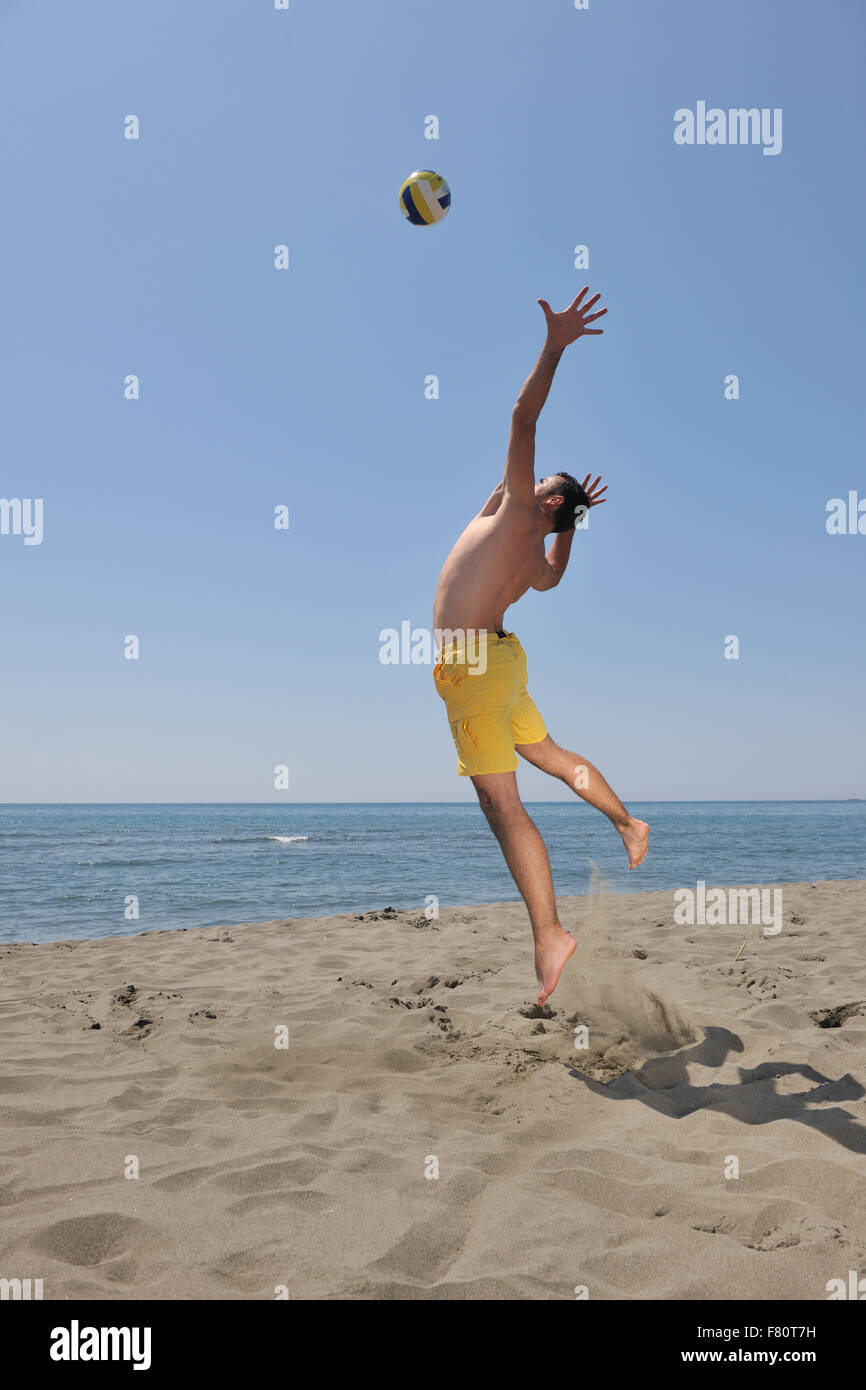male beach volleyball game player jump on hot sand Stock Photo - Alamy