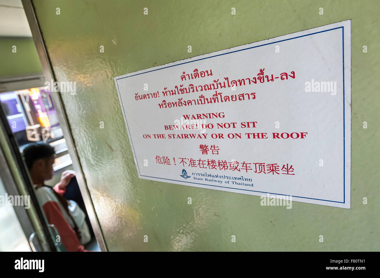 Warning sign onboard a Thai train Stock Photo - Alamy