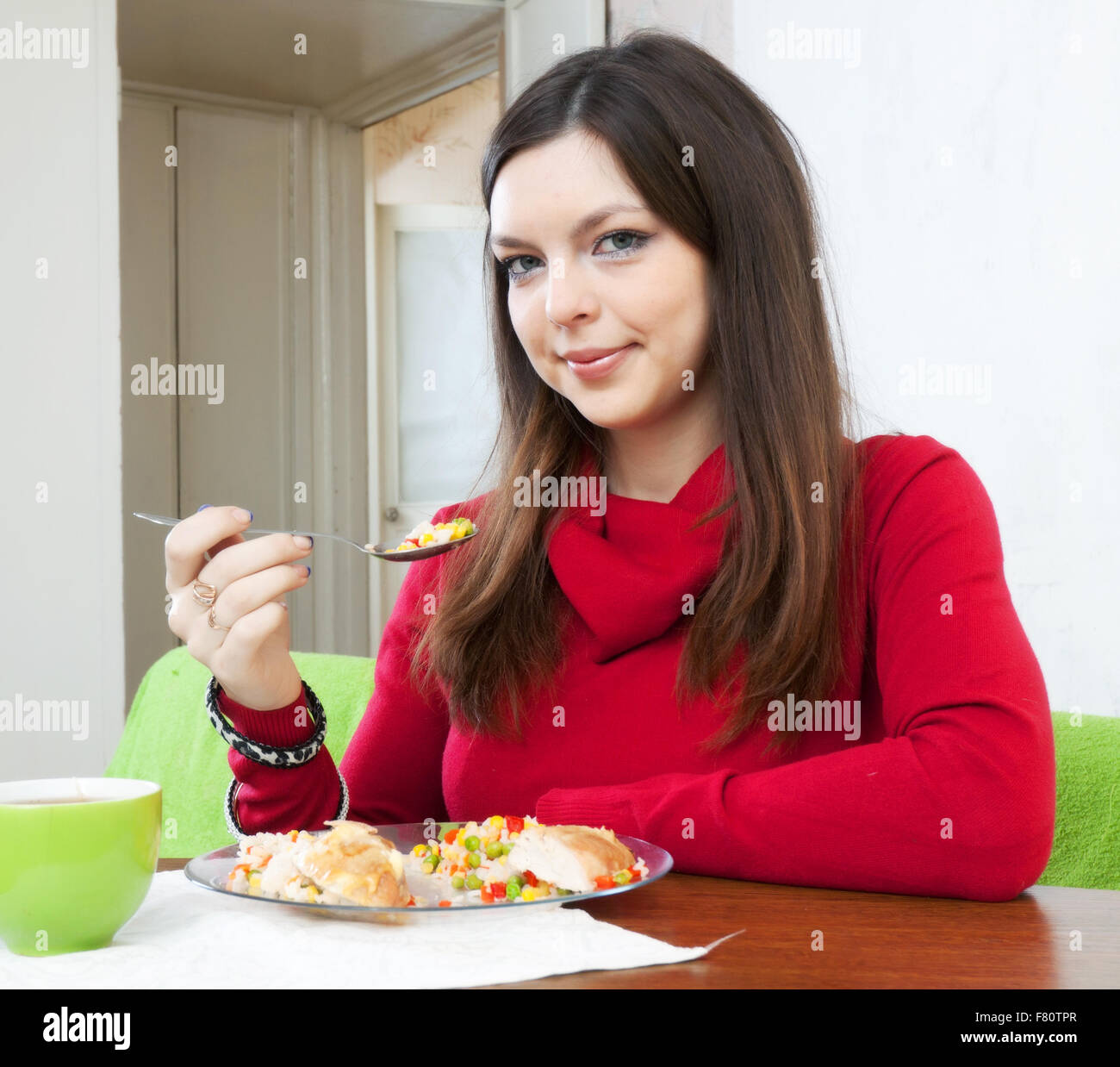 Brunette woman having dinner at her home Stock Photo - Alamy
