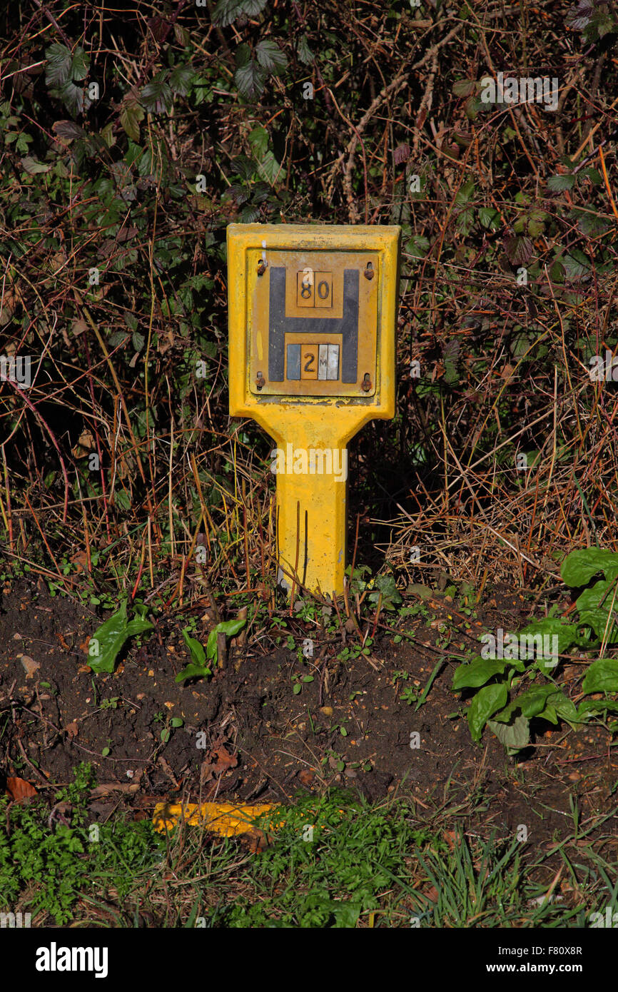 Fire Hydrant warning post in concrete with a yellow sign with black ...