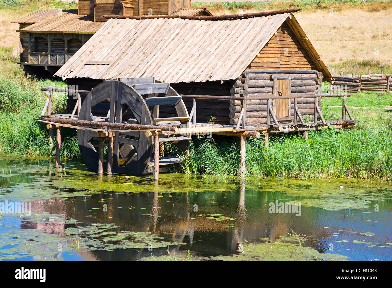 Vintage wooden water mill on river in summer Stock Photo - Alamy