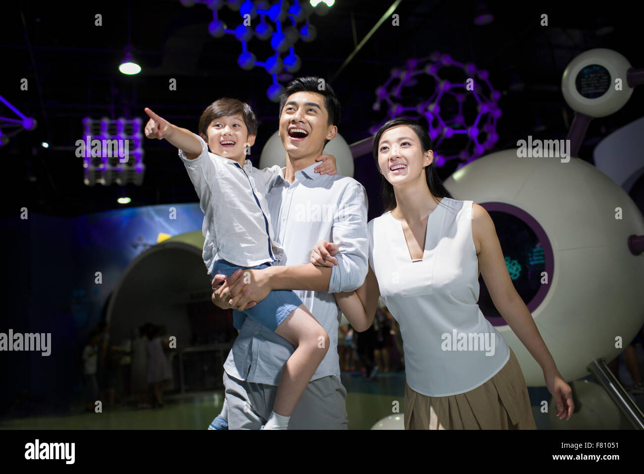 Young family in science and technology museum Stock Photo - Alamy