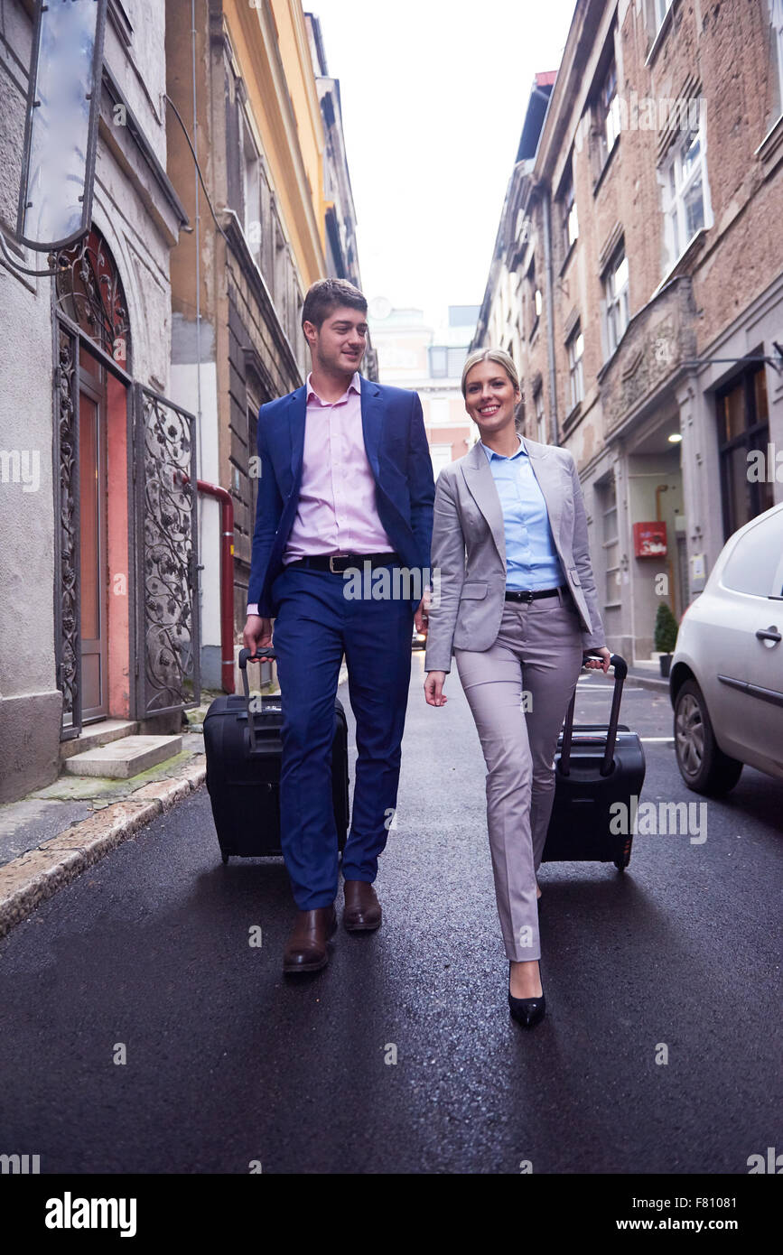 Young business people couple entering city hotel, looking for room ...