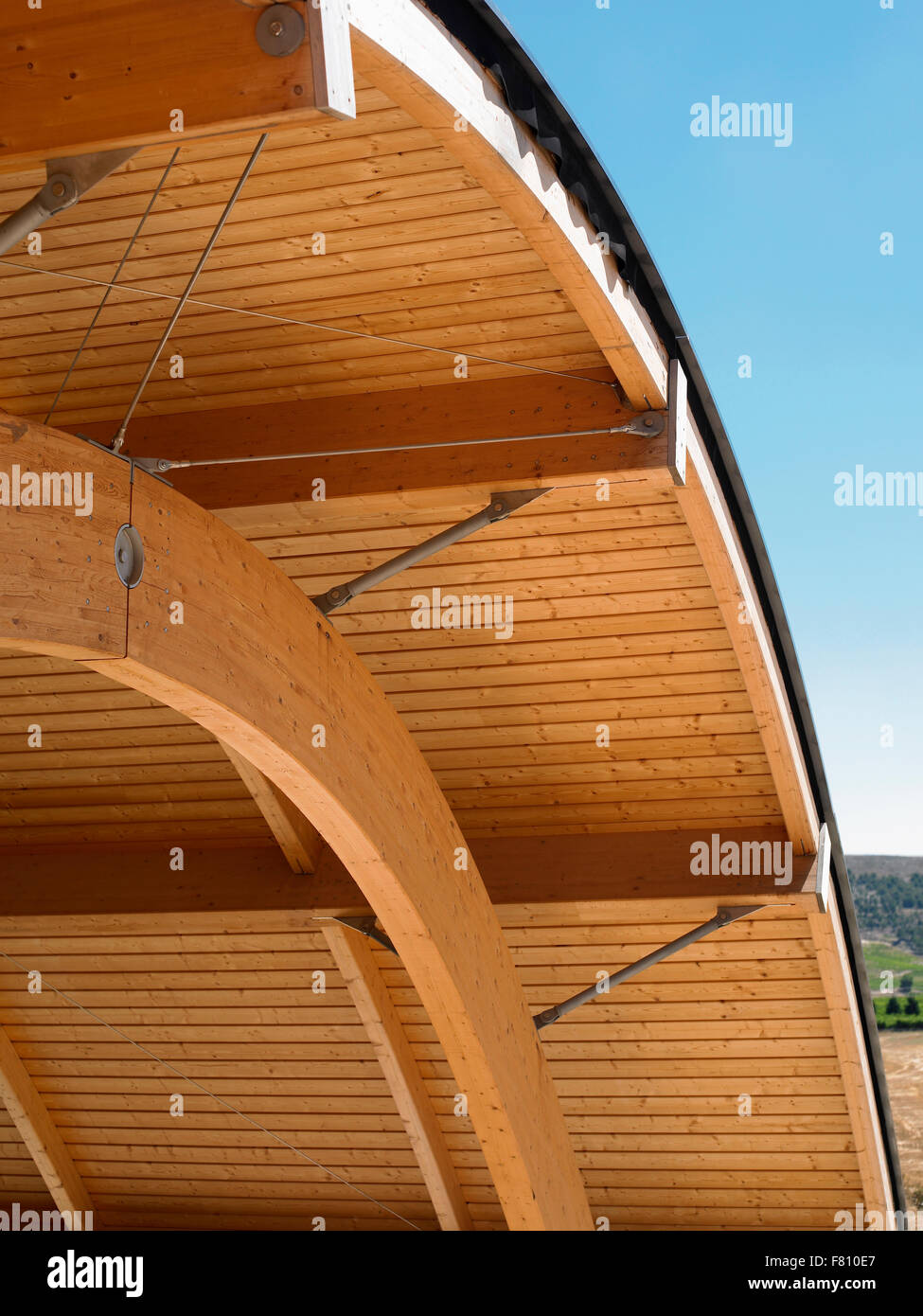 Wooden curved roof against blue sky vertical Stock Photo - Alamy