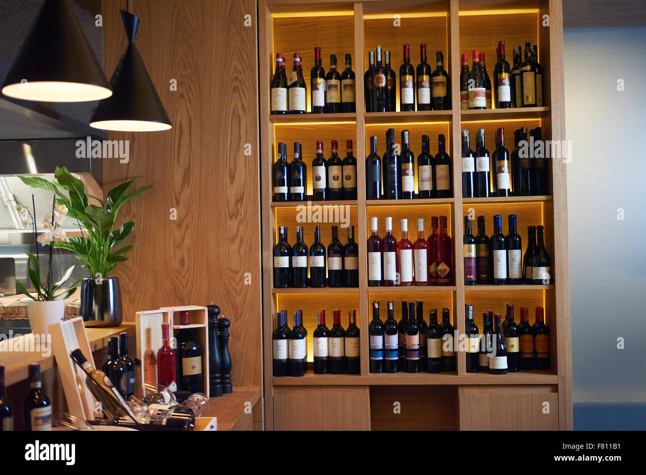 Wine bottles on a wooden shelf in modern restaurant interior Stock ...