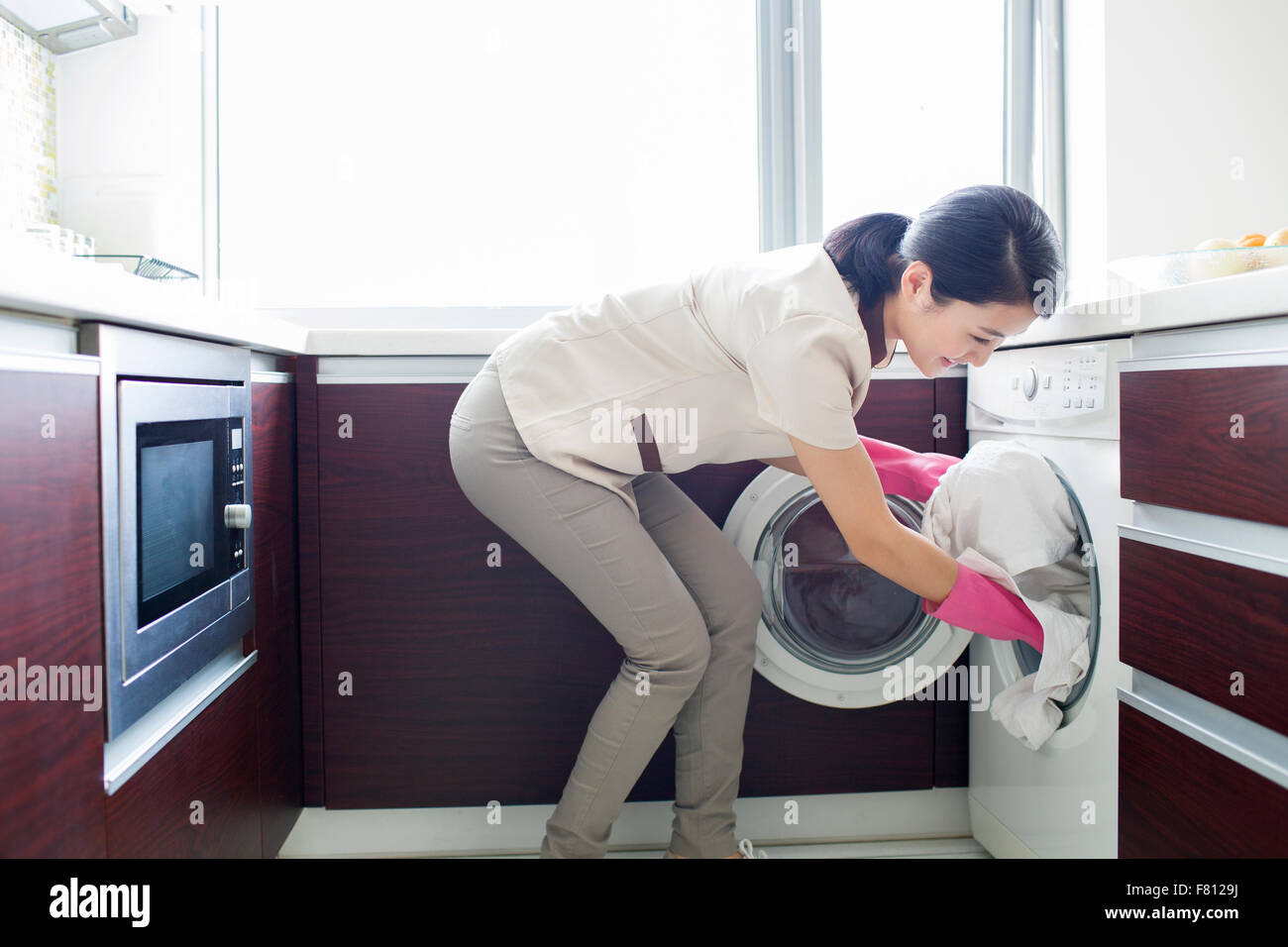Domestic staff doing laundry Stock Photo - Alamy
