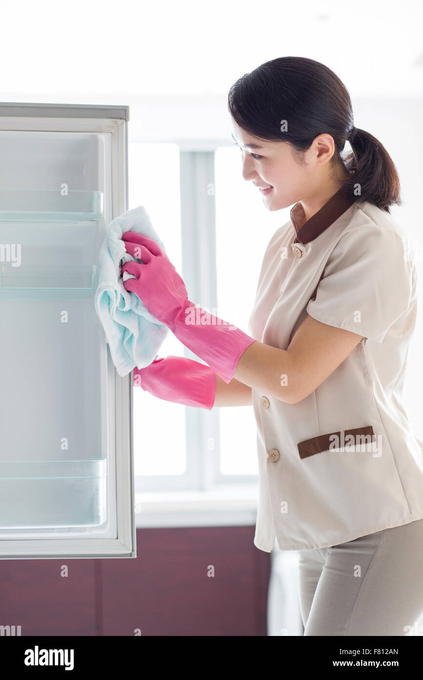 Domestic staff cleaning refrigerator Stock Photo - Alamy