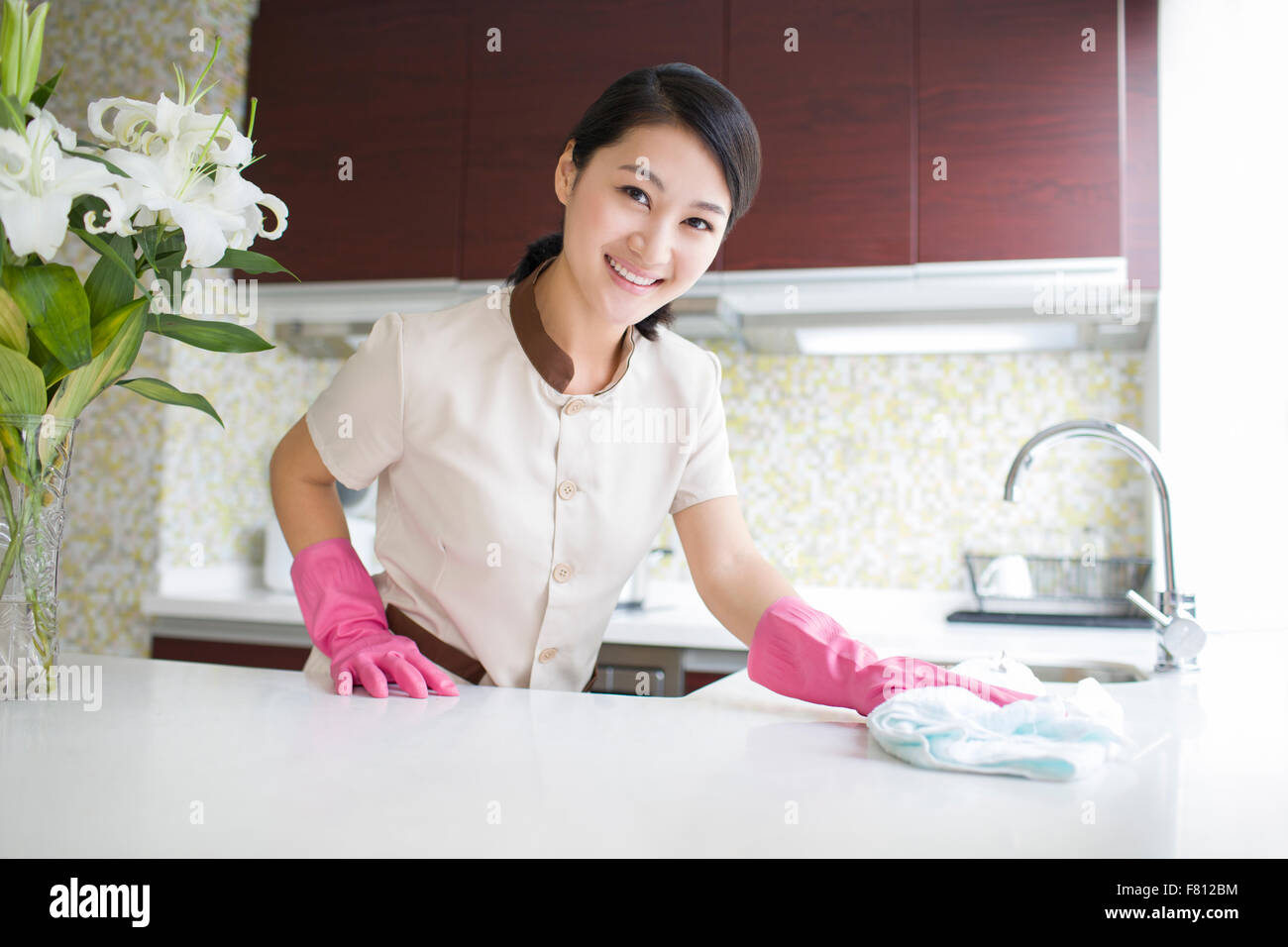 Domestic staff cleaning kitchen Stock Photo - Alamy