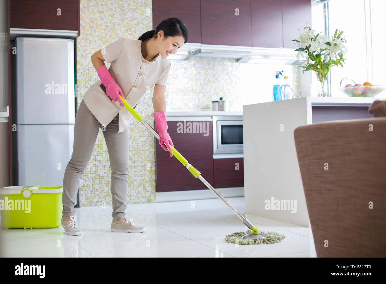 Domestic staff cleaning kitchen Stock Photo - Alamy