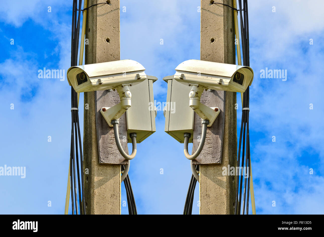 Two closed circuit camera on blue sky background Stock Photo - Alamy