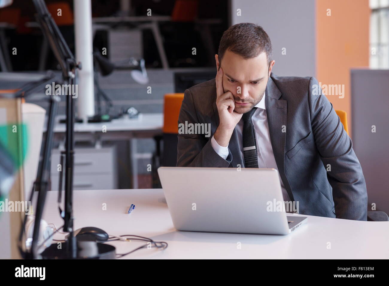 frustrated young business man working on laptop computer at office ...