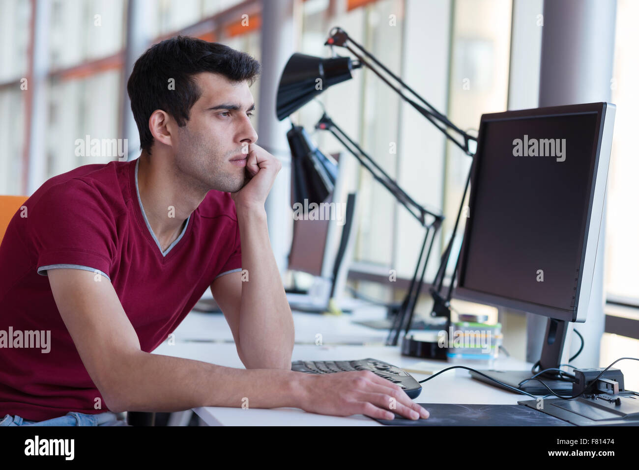 frustrated young business man working on laptop computer at office ...
