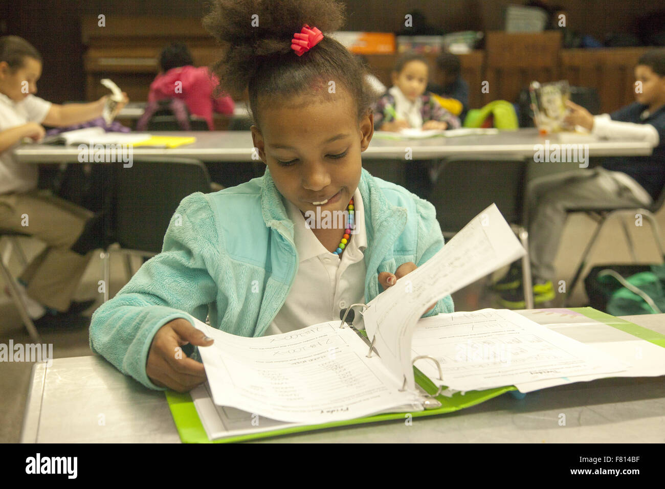 Children study and do homework after school at a community center ...