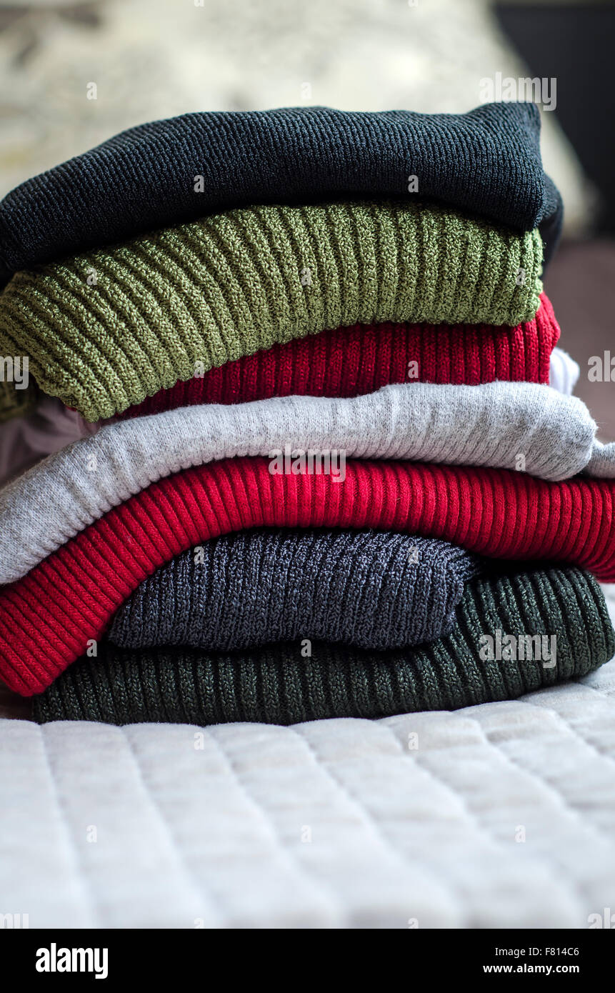 Warm winter sweaters piled up. Close up Stock Photo - Alamy