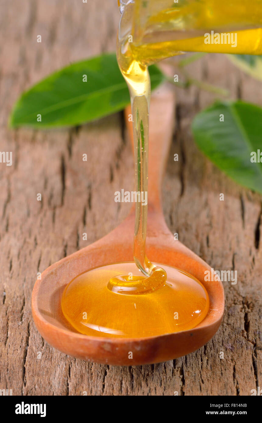Honey dripping from a jar Stock Photo - Alamy
