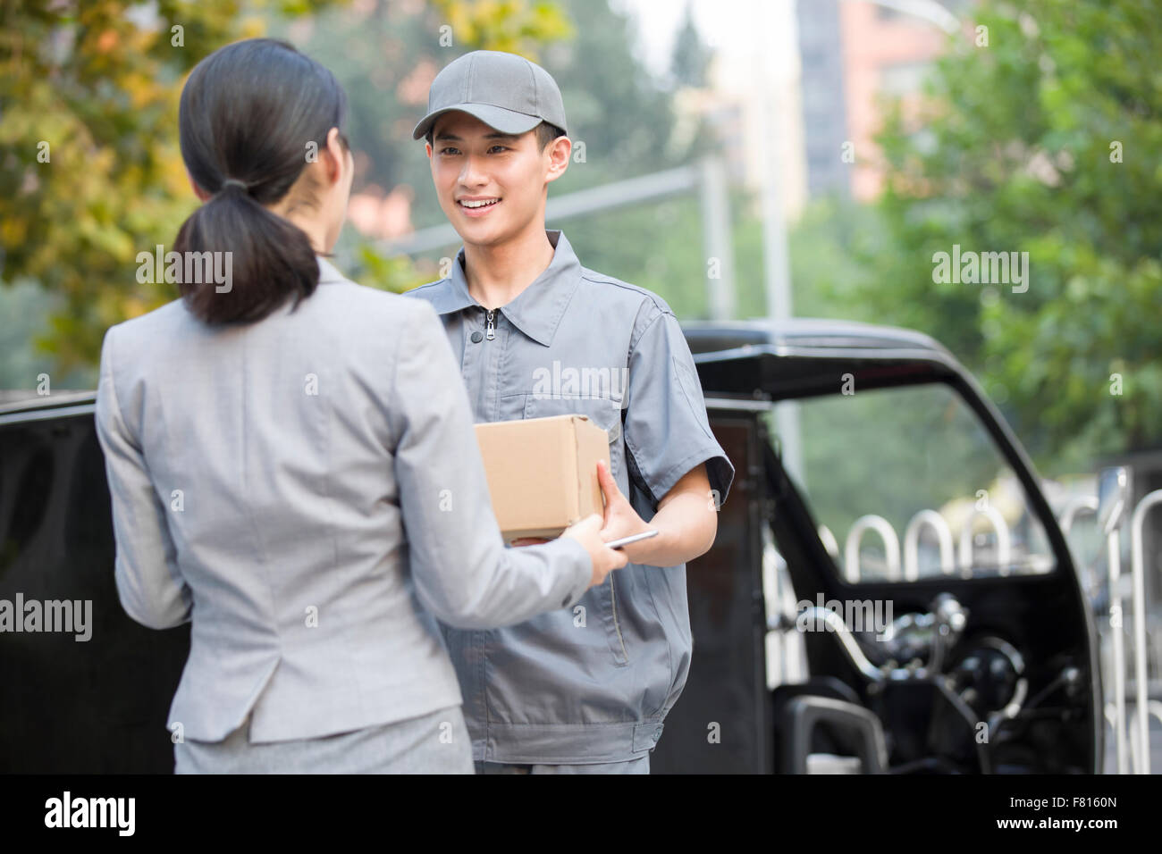 Office person holding a package hi-res stock photography and images - Alamy
