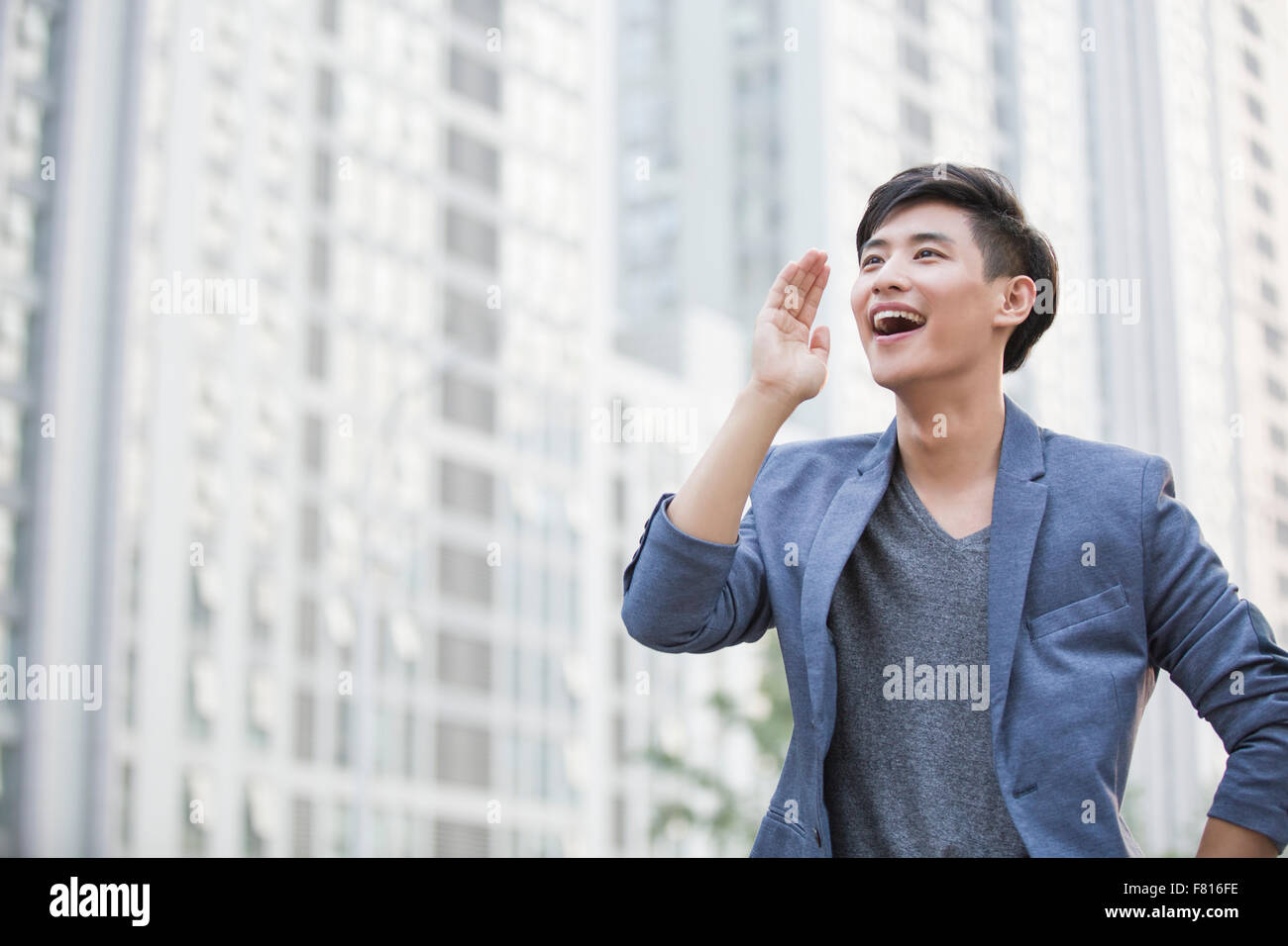 Happy young man shouting Stock Photo - Alamy