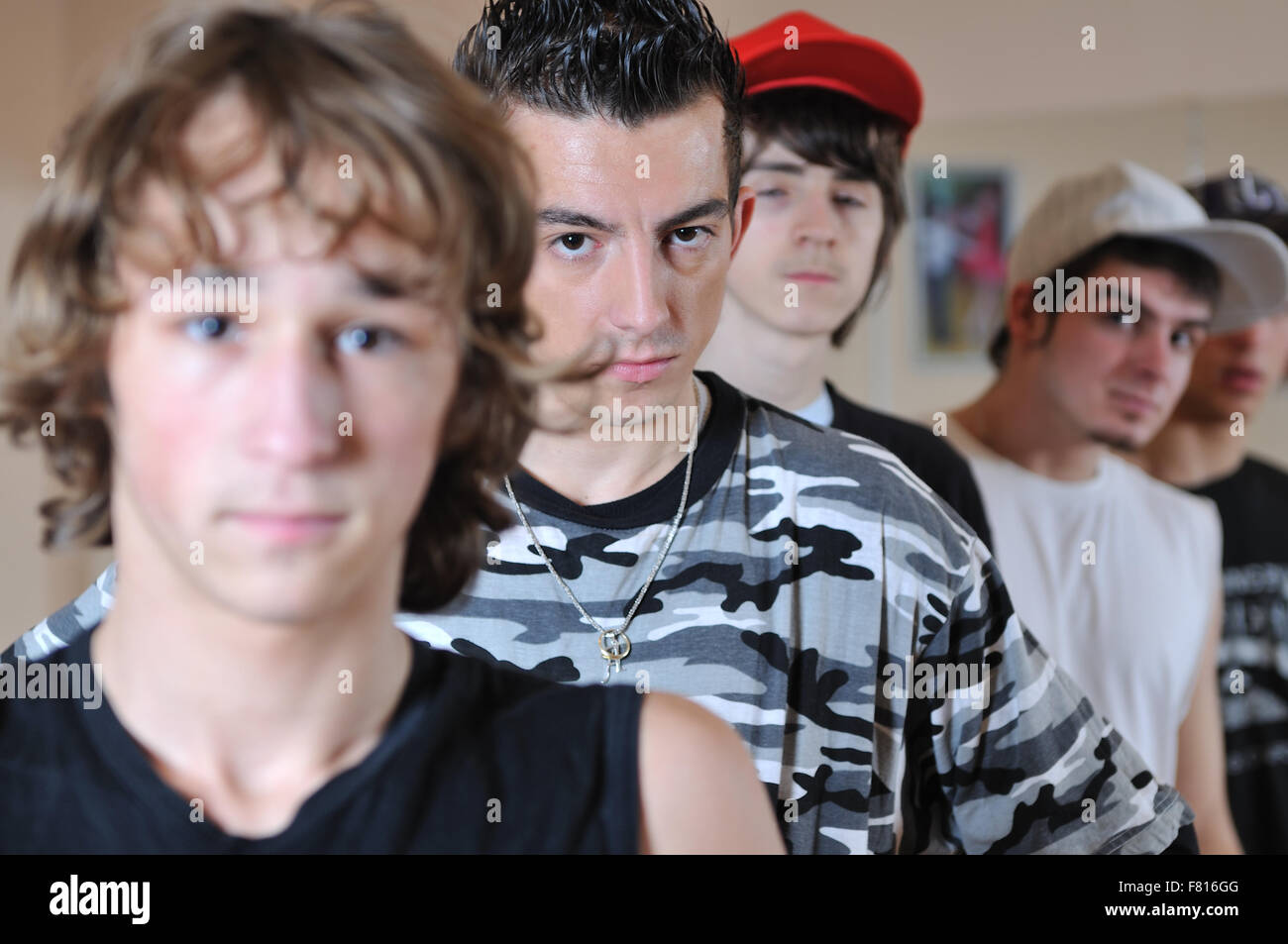 group of young happy boys posing together in dence studio Stock Photo ...