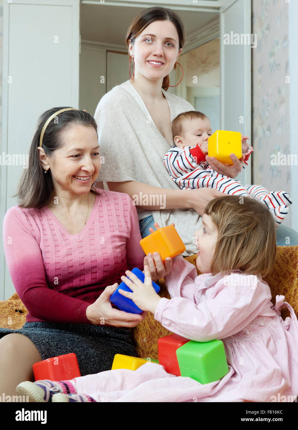 Happy women with children in home interior Stock Photo - Alamy