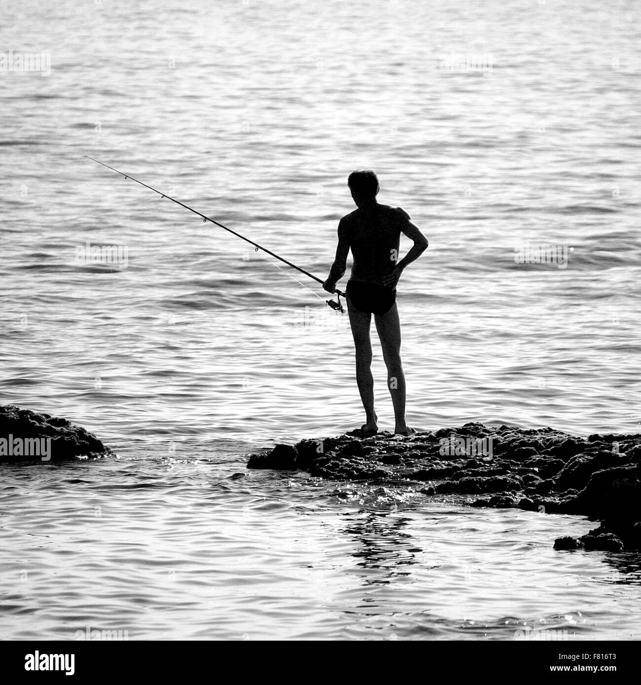Fisherman waiting for his catch at sea Stock Photo - Alamy
