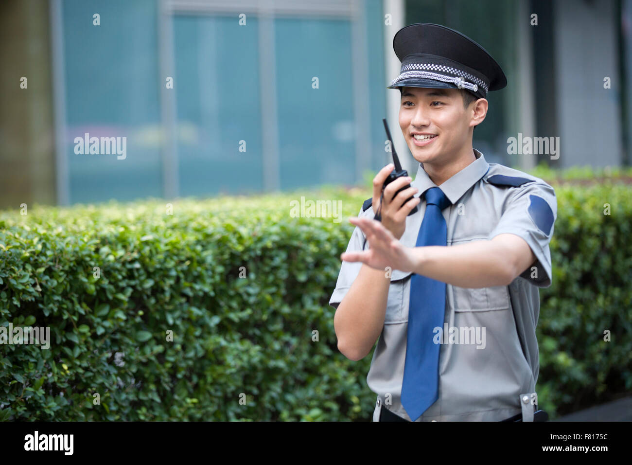 Standing looking away smiling security guard confidence communication ...