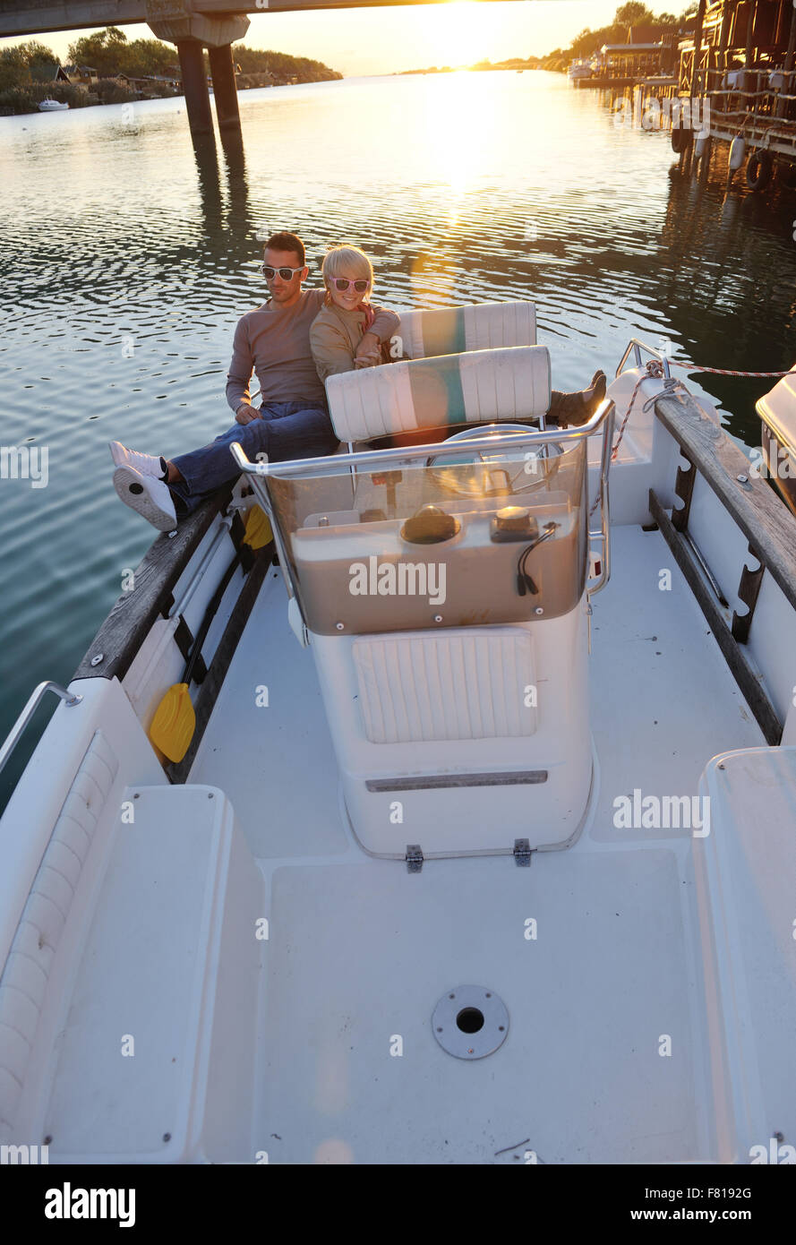 happy young couple in love have romantic time at summer sunset at ship ...