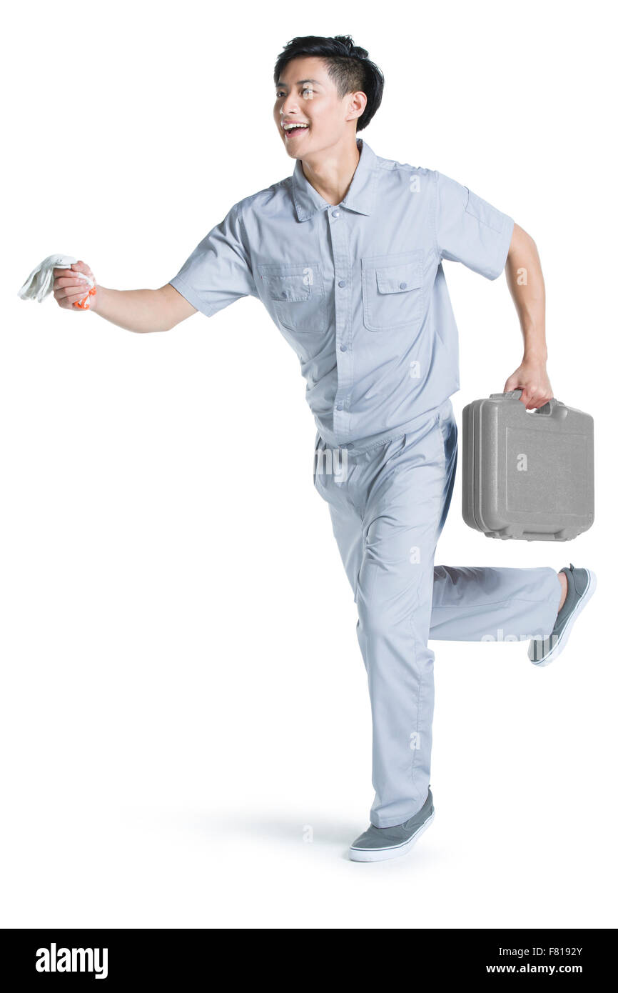 Repairman running with toolbox Stock Photo - Alamy