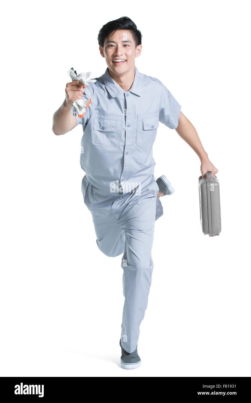 Repairman running with toolbox Stock Photo - Alamy