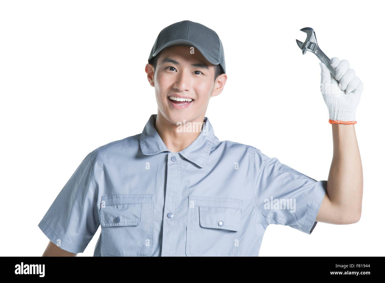 Repairman holding a spanner Stock Photo - Alamy