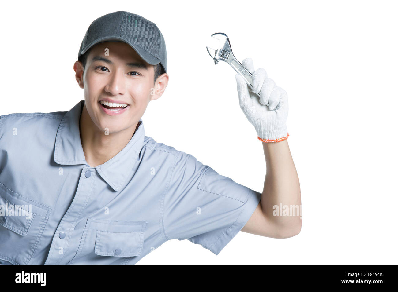 Repairman holding a spanner Stock Photo - Alamy