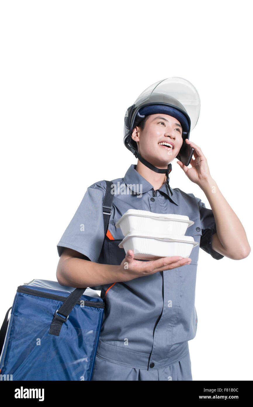 Take-out deliveryman talking on the phone Stock Photo - Alamy