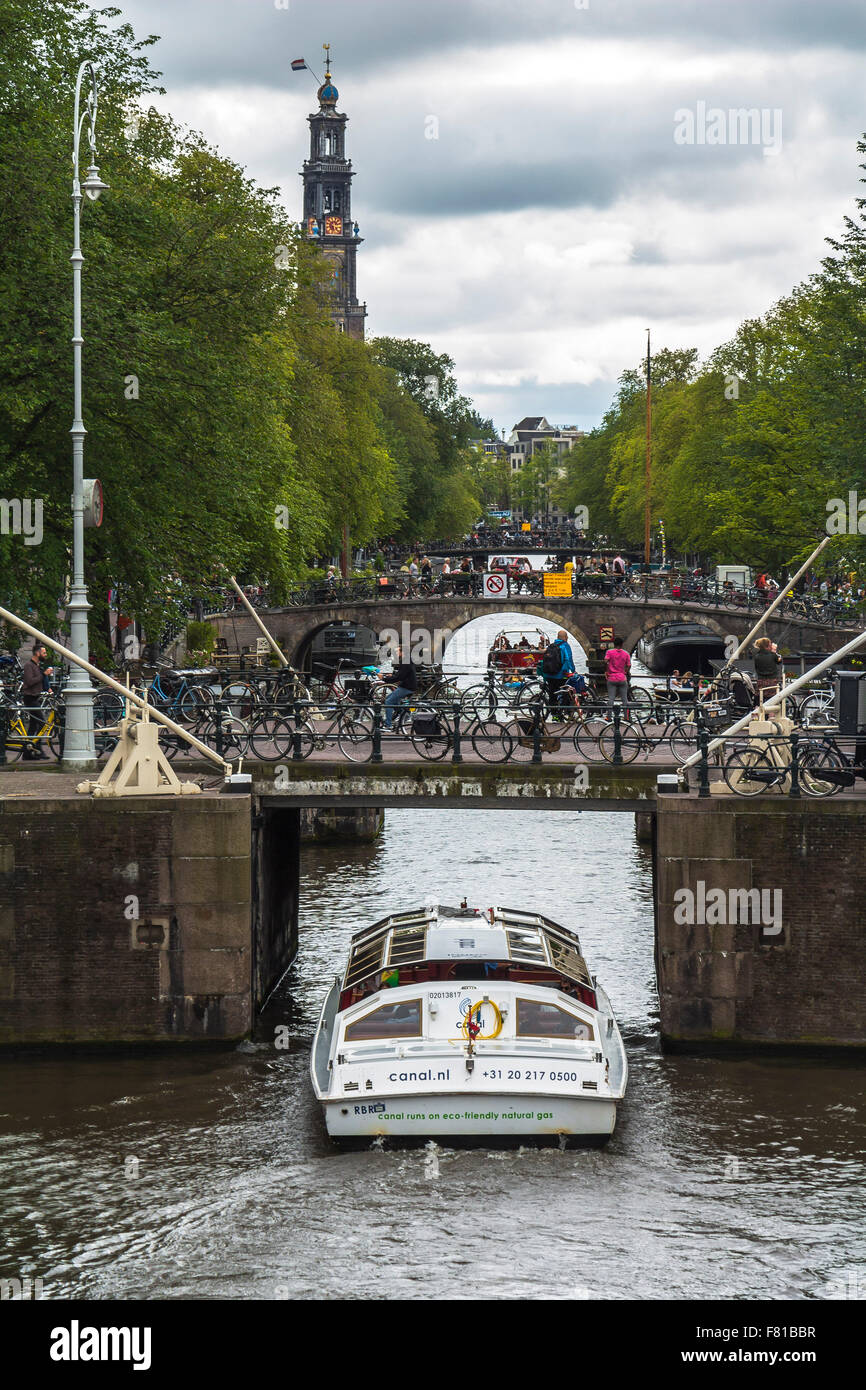 Boat under bridge over a canal in Amsterdam Stock Photo - Alamy