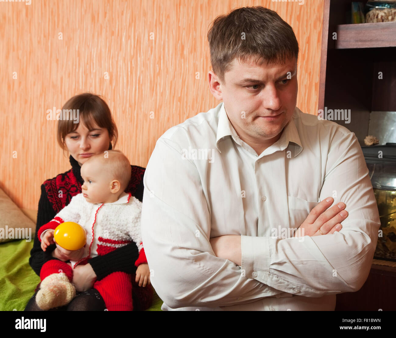 Family of three having quarrel at home Stock Photo - Alamy