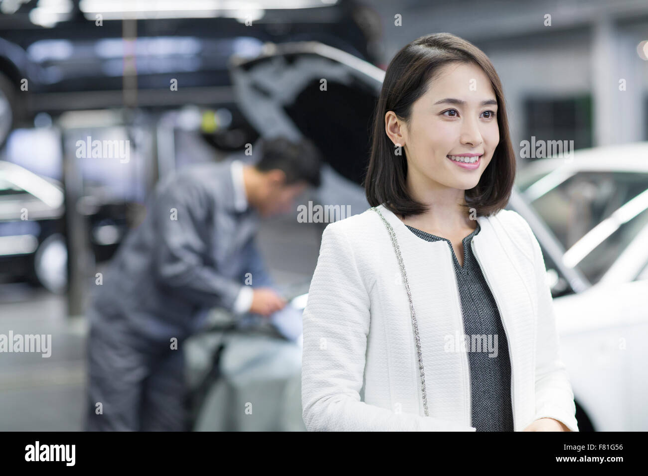 Young woman in repair shop with her car Stock Photo - Alamy