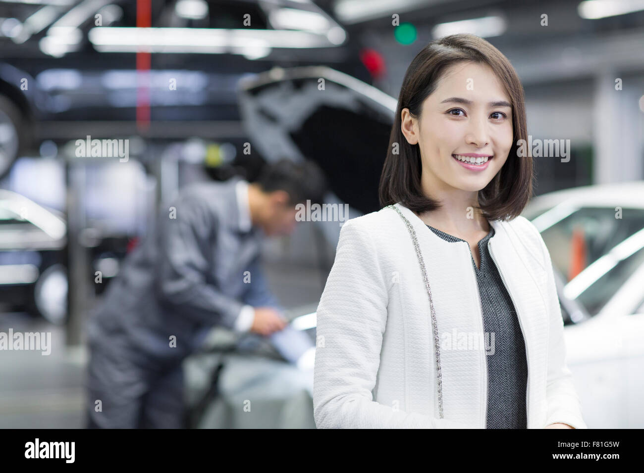 Young woman in repair shop with her car Stock Photo - Alamy