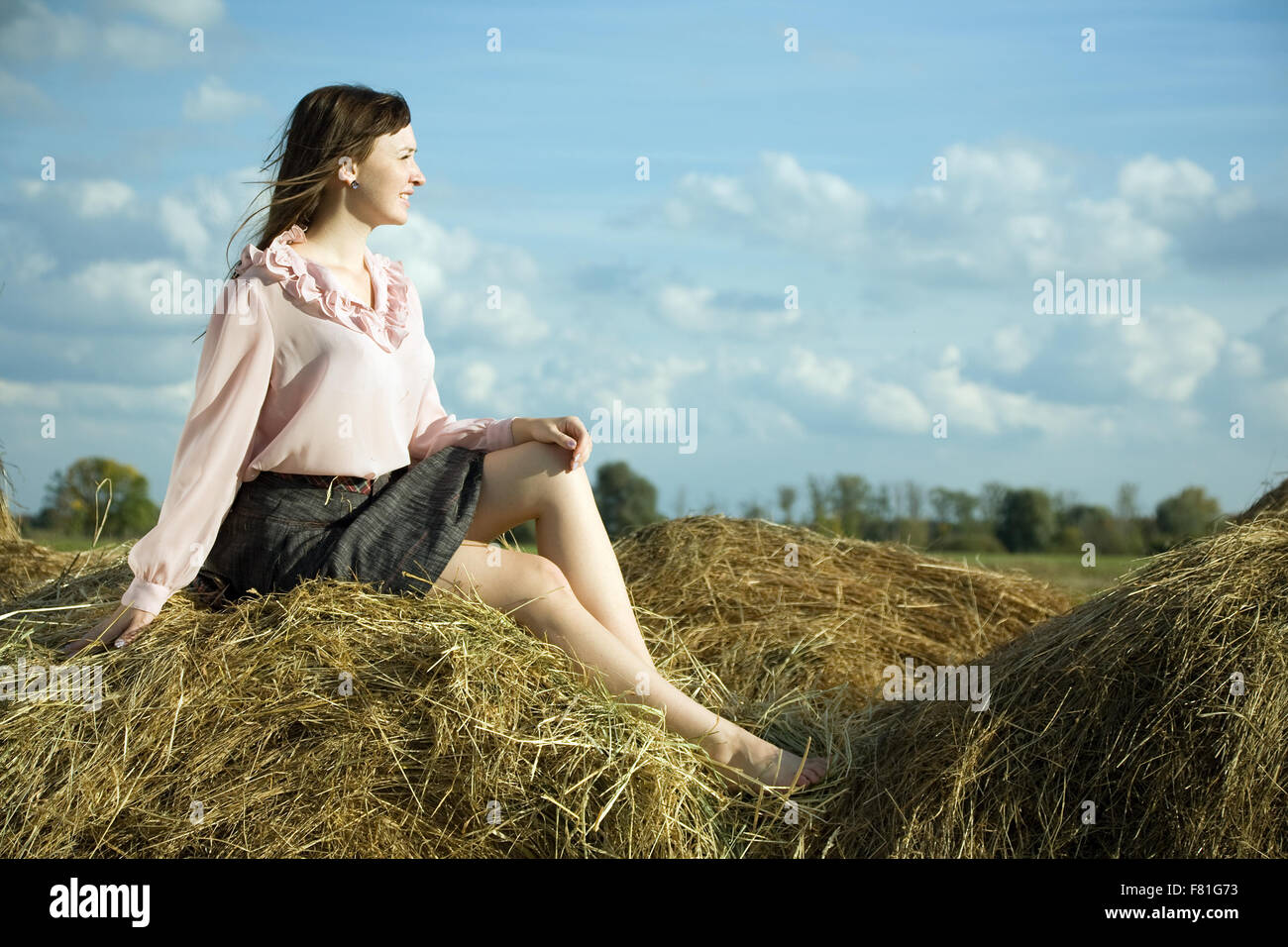 country girl on fresh hay at field Stock Photo - Alamy