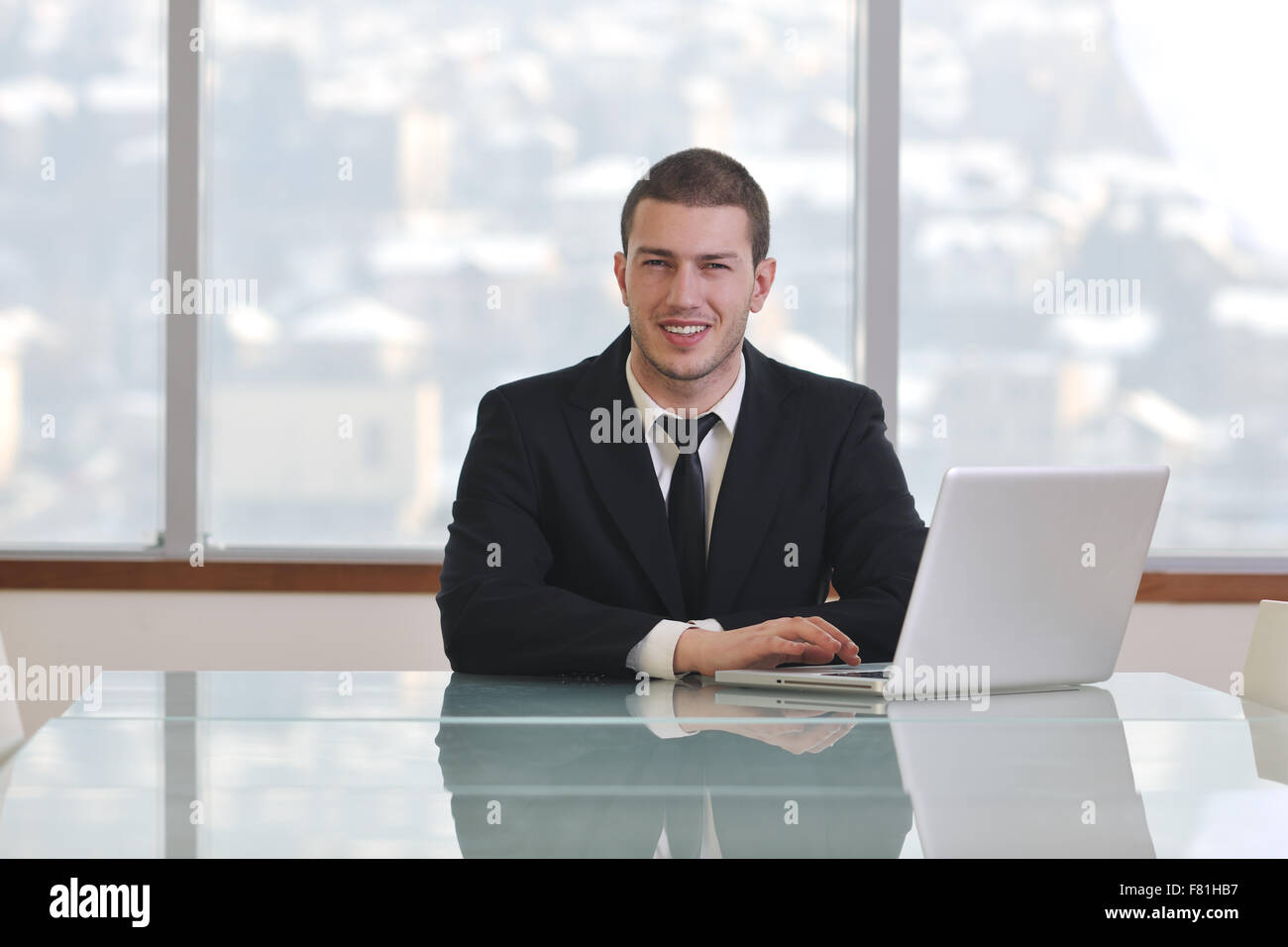 young business man lawyer with laptop alone in big bright conference ...