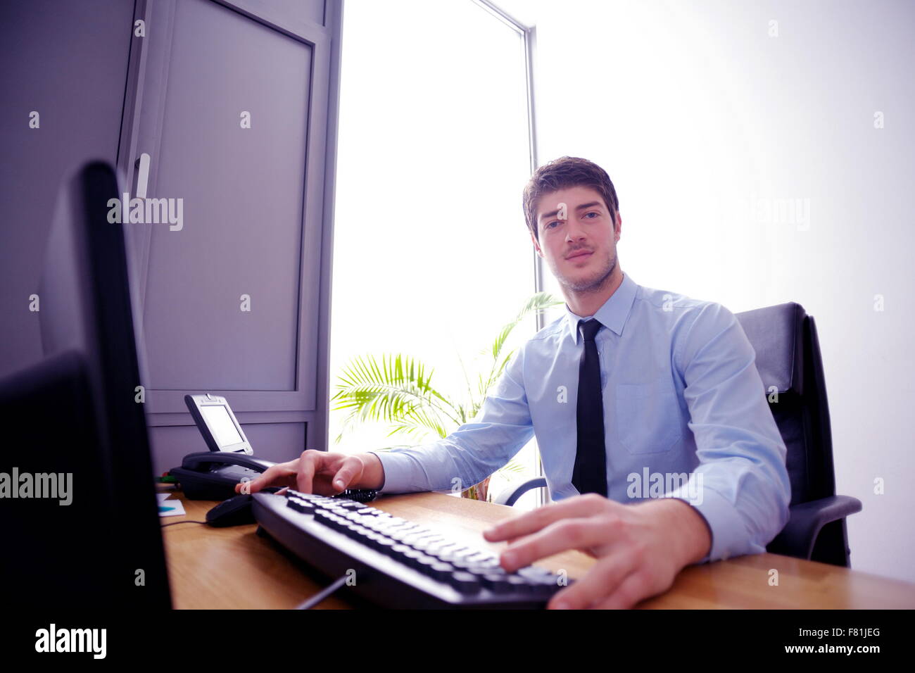 happy young business man work in modern office on computer Stock Photo ...