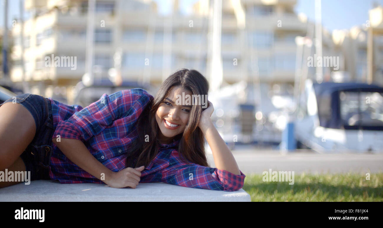 Girl Lying On A Park Bench Stock Photo - Alamy