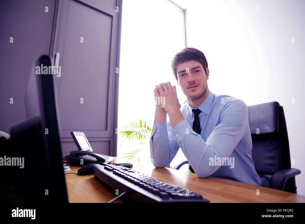 happy young business man work in modern office on computer Stock Photo ...