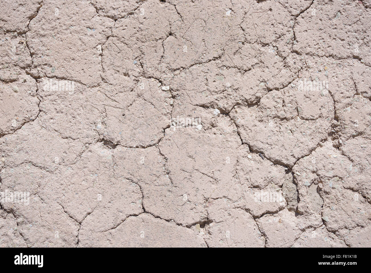 Adobe wall with scratches and spots. Adobe is building material made ...