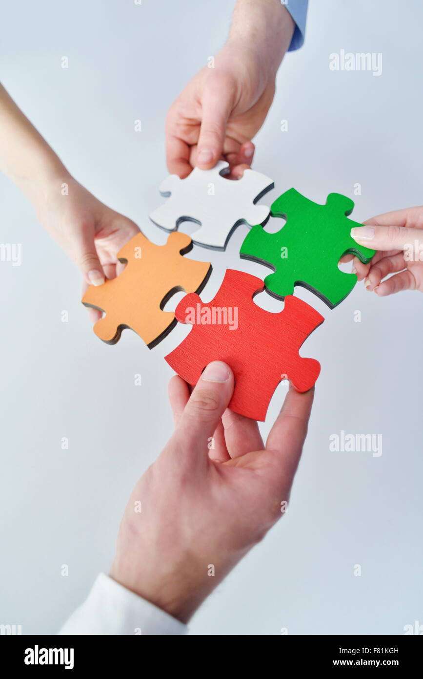 Group of business people assembling jigsaw puzzle and represent team ...