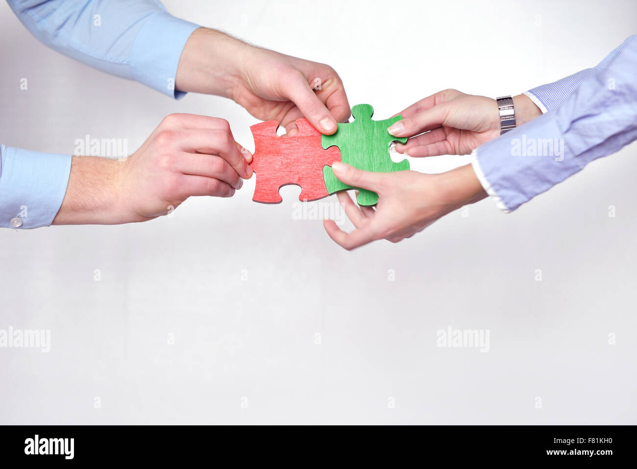 Group of business people assembling jigsaw puzzle and represent team ...